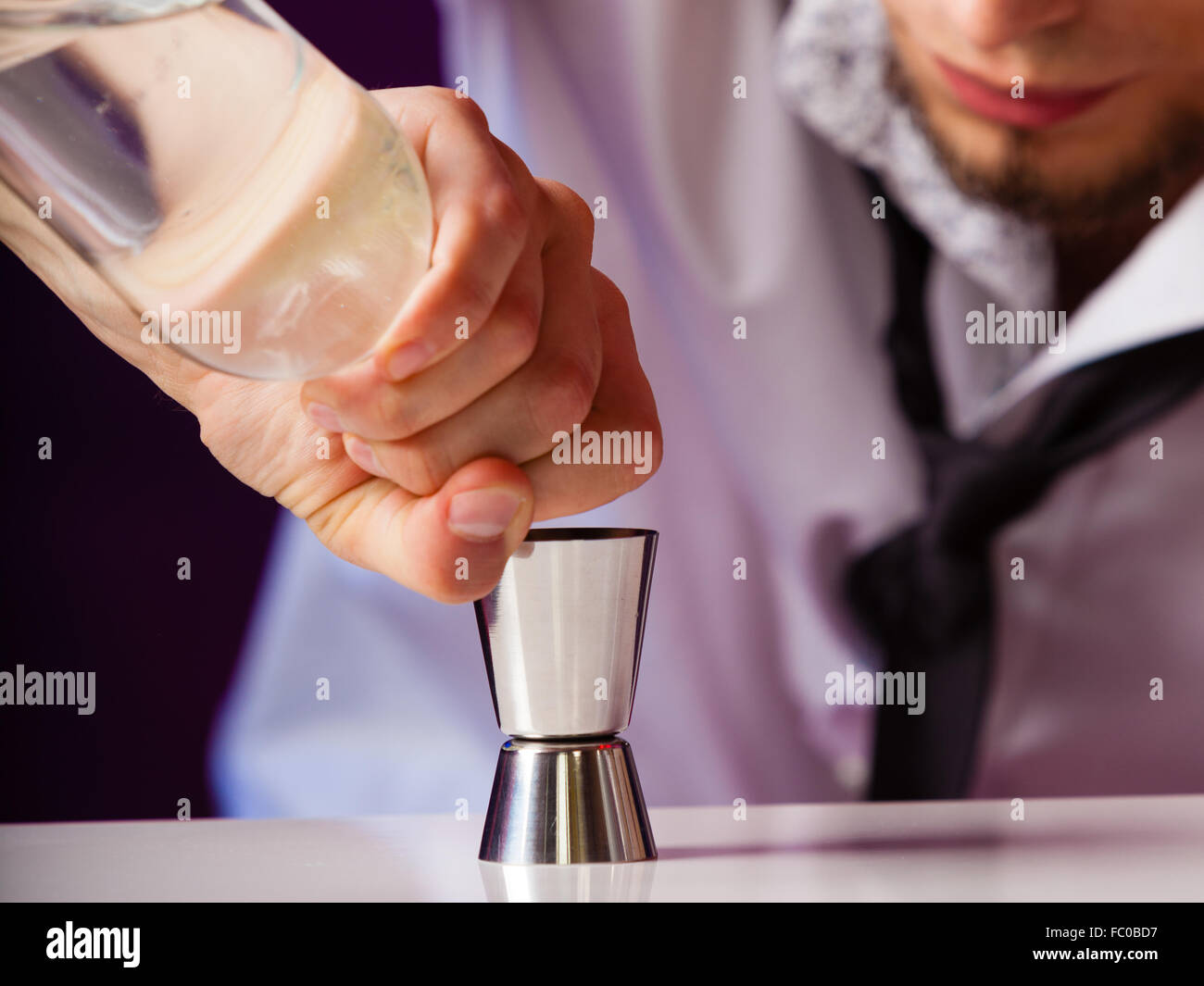 Young man bartender preparing alcohol drink Stock Photo - Alamy
