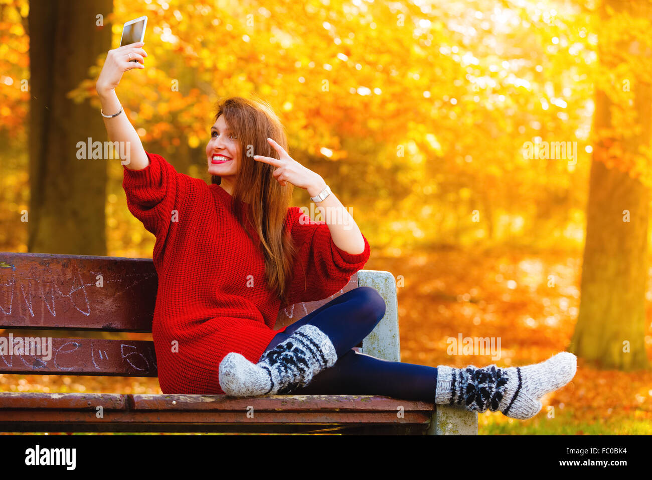 girl taking self picture selfie with smartphone camera outdoors Stock ...