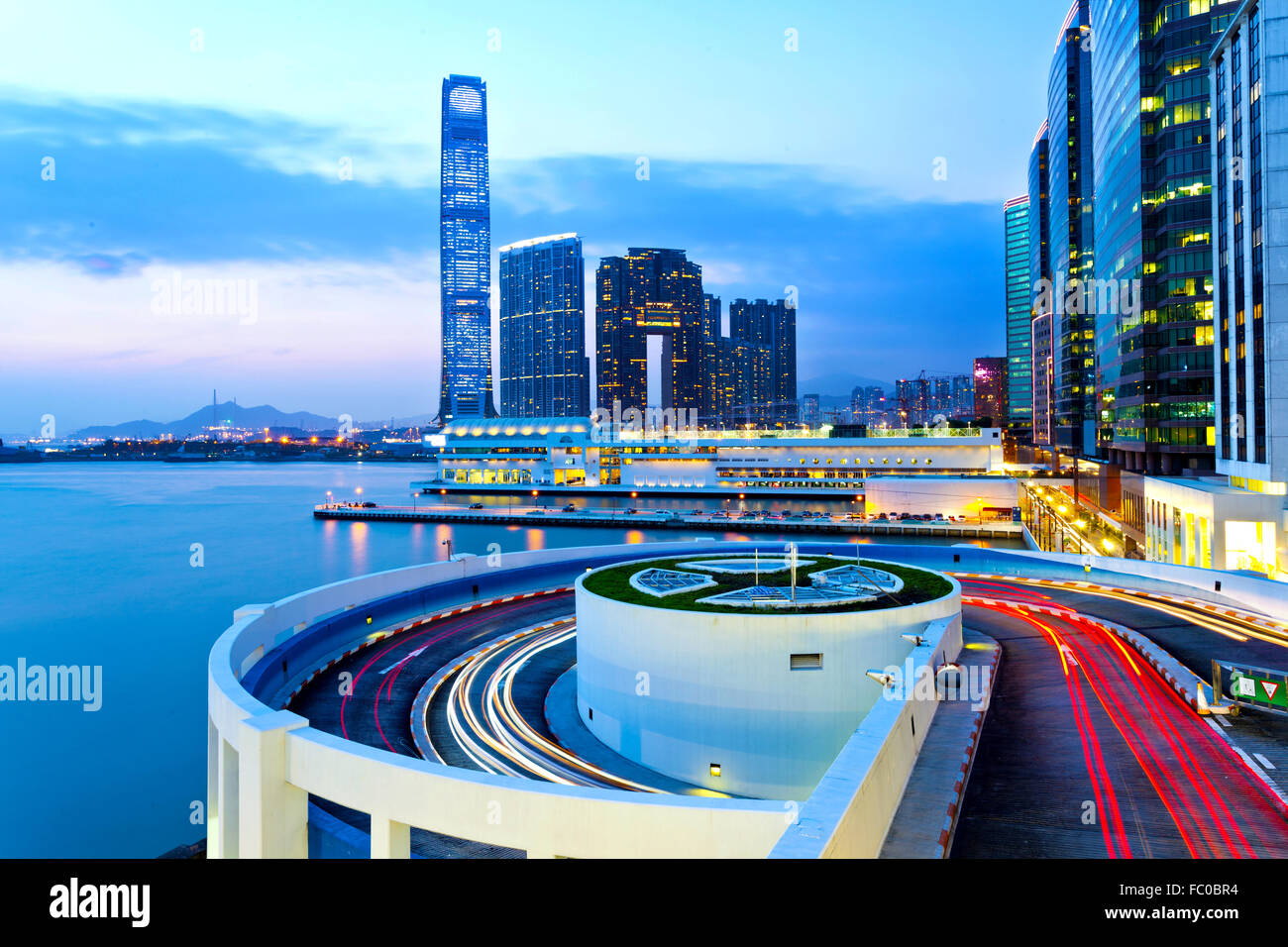 Moving light trails with modern buildings background Stock Photo - Alamy