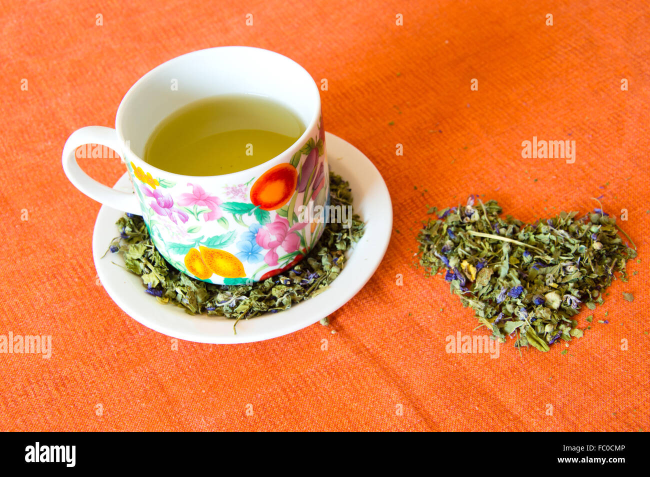 Mallow herbal tea cup on orange background Stock Photo - Alamy