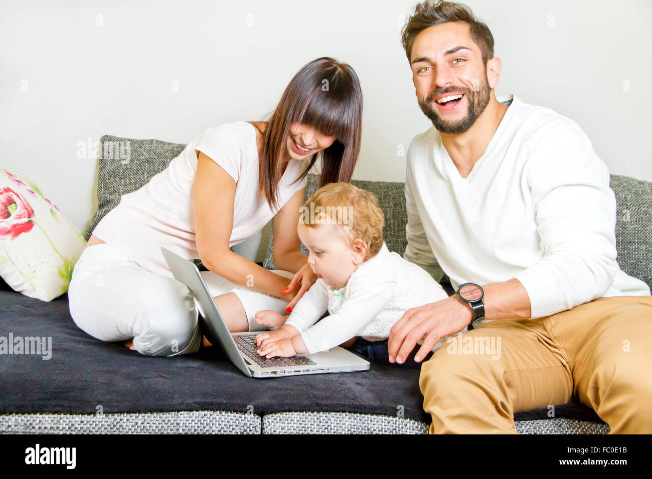 Happy family with computer Stock Photo - Alamy