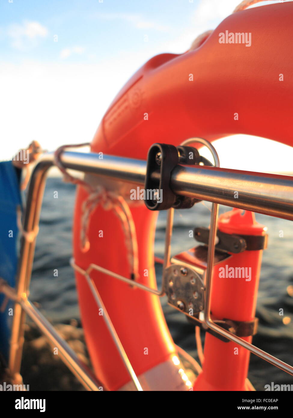 Rescue red lifebuoy on sail and blue sky sea Stock Photo - Alamy
