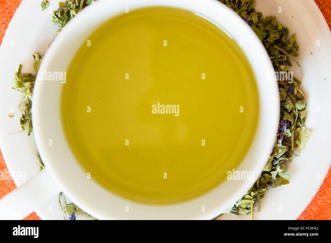 Mallow herbal tea cup on orange background Stock Photo - Alamy