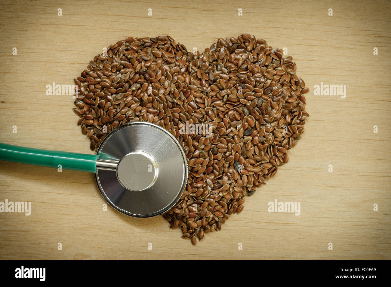 Raw flax seeds heart shaped and stethoscope Stock Photo - Alamy