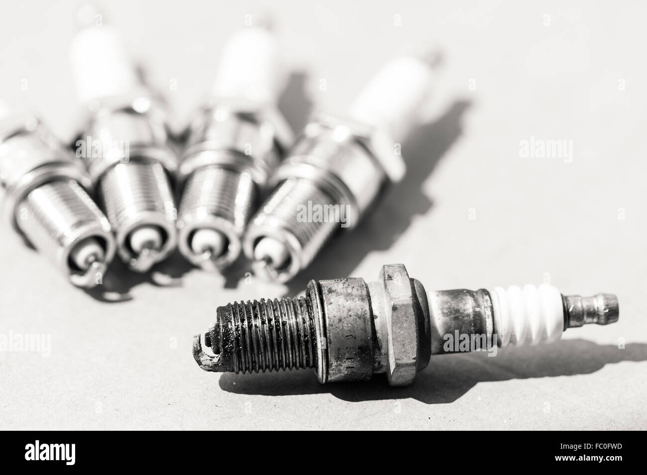 Auto service. Set of spark plugs as spare part of car Stock Photo - Alamy