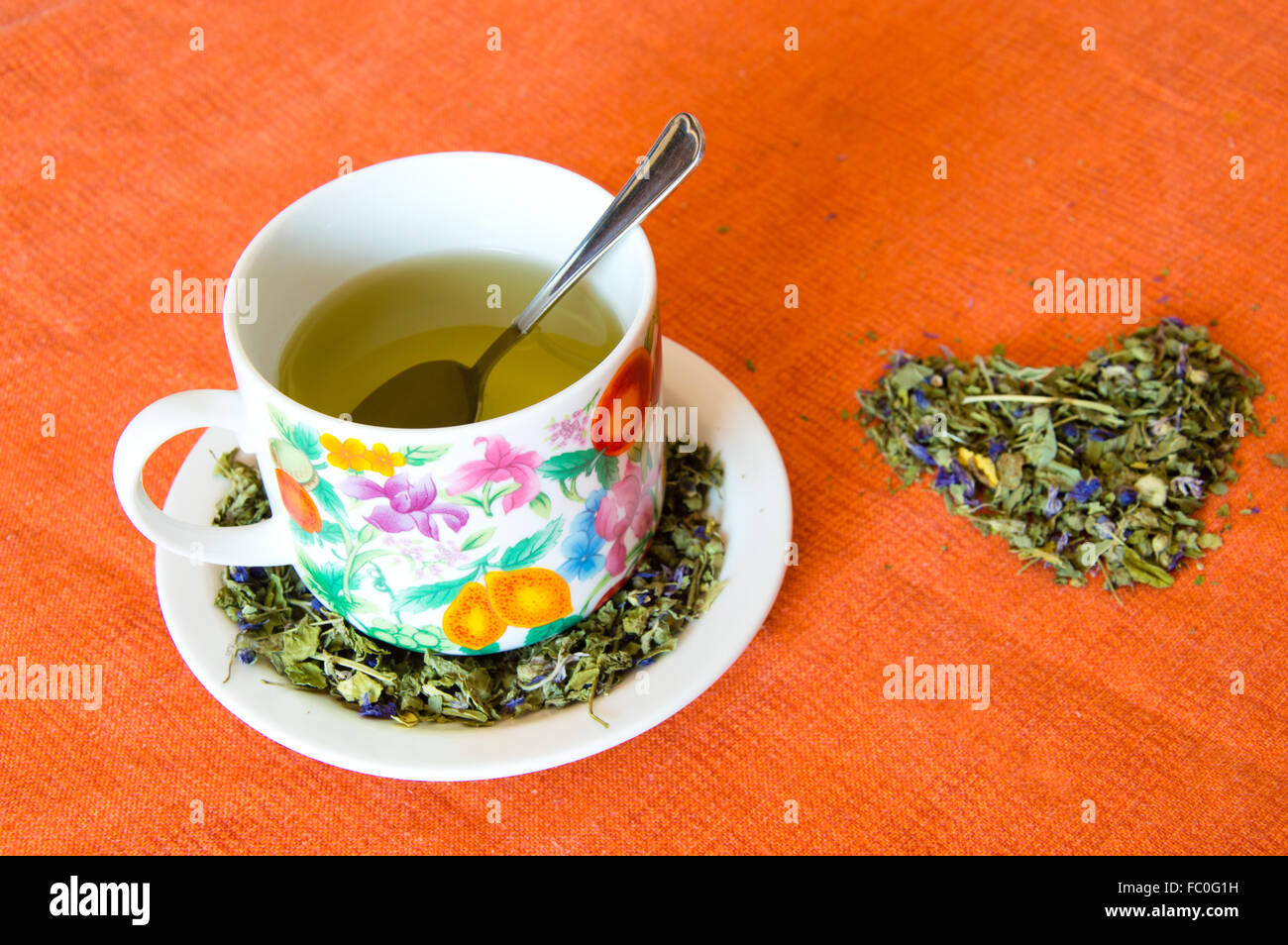 Mallow herbal tea cup on orange background Stock Photo - Alamy