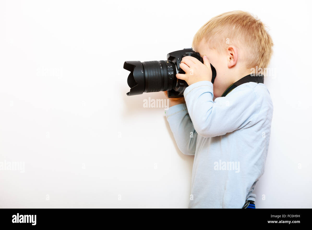 Boy child playing with camera taking photo Stock Photo - Alamy