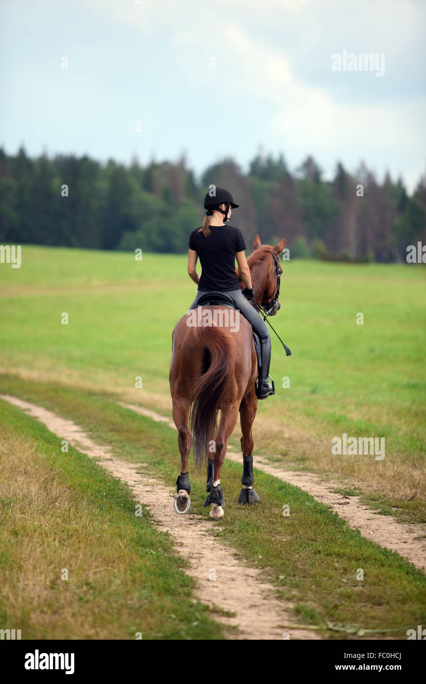 Woman riding horse rear hi-res stock photography and images - Alamy