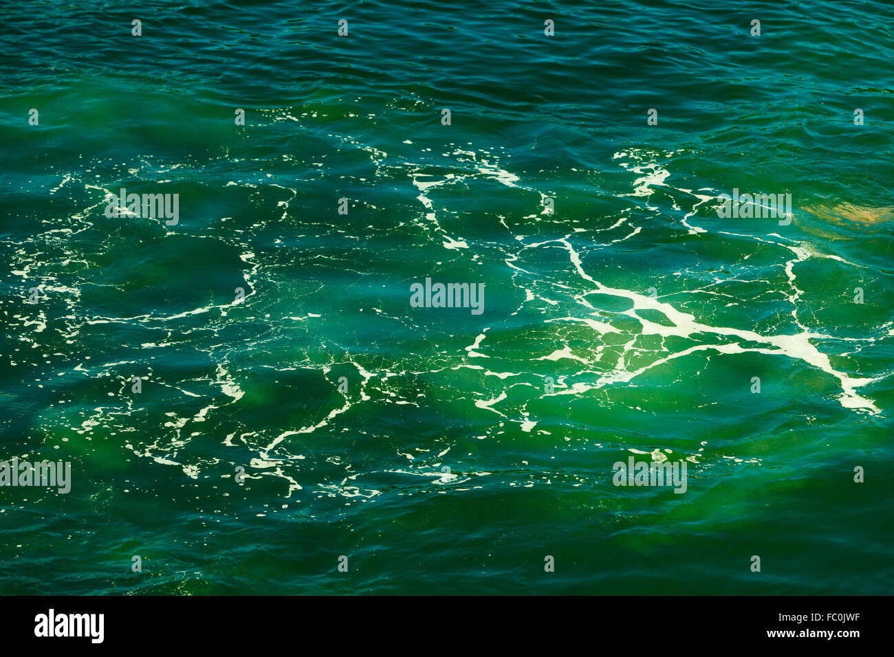 Sea bottom with blue water wave splash background Stock Photo - Alamy