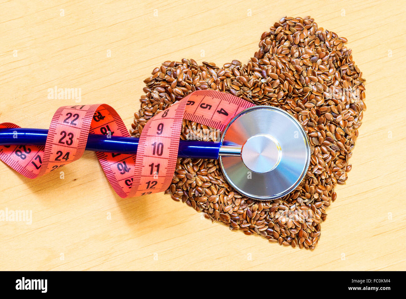Raw flax seeds heart shaped and stethoscope Stock Photo - Alamy