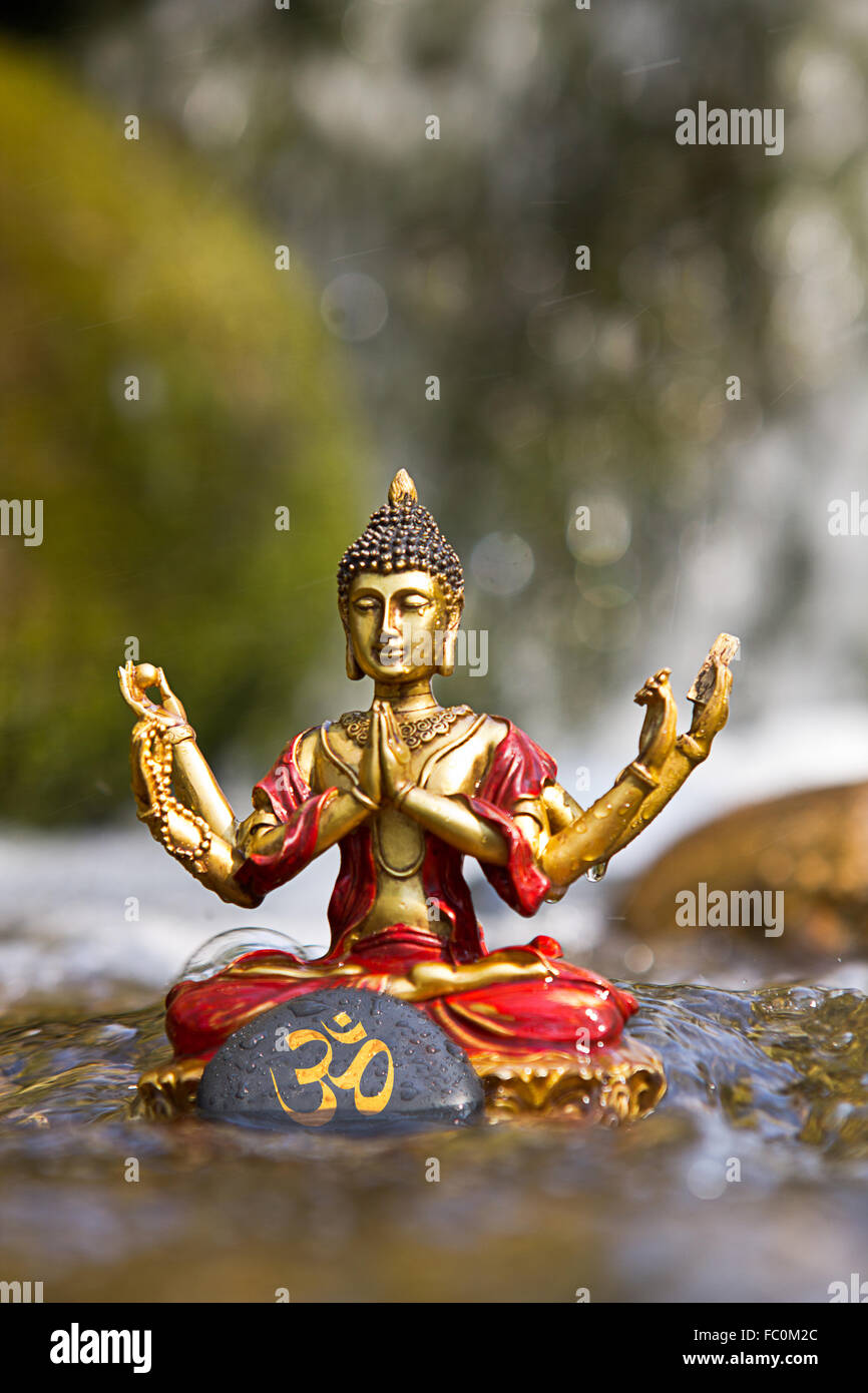 Buddha statue with the Om Sign Stock Photo - Alamy