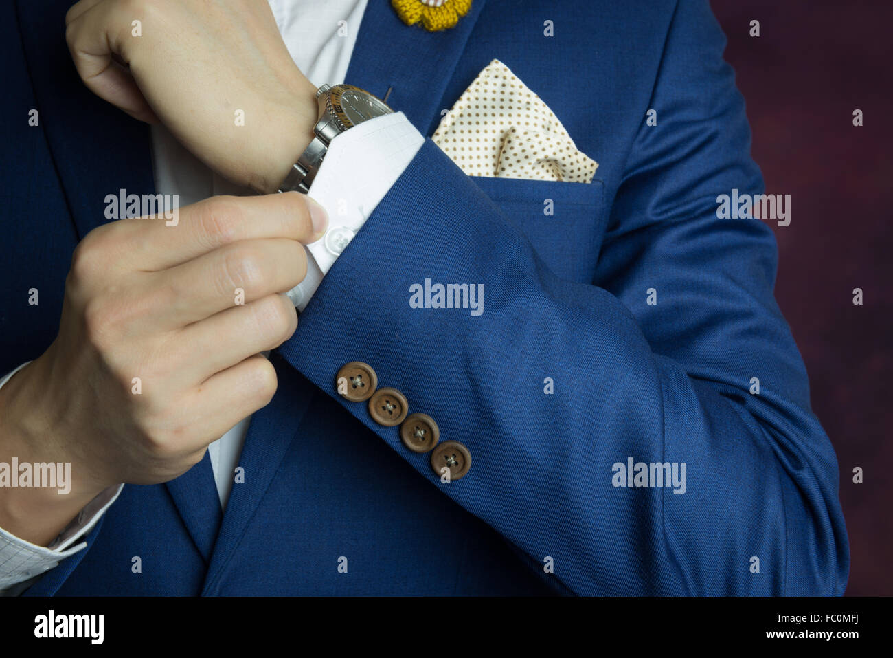 Man in blue suit two bottons, doing button, close up Stock Photo - Alamy
