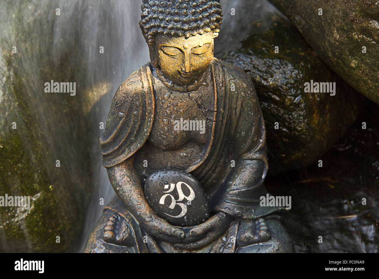 Buddha statue with the Om Sign Stock Photo - Alamy