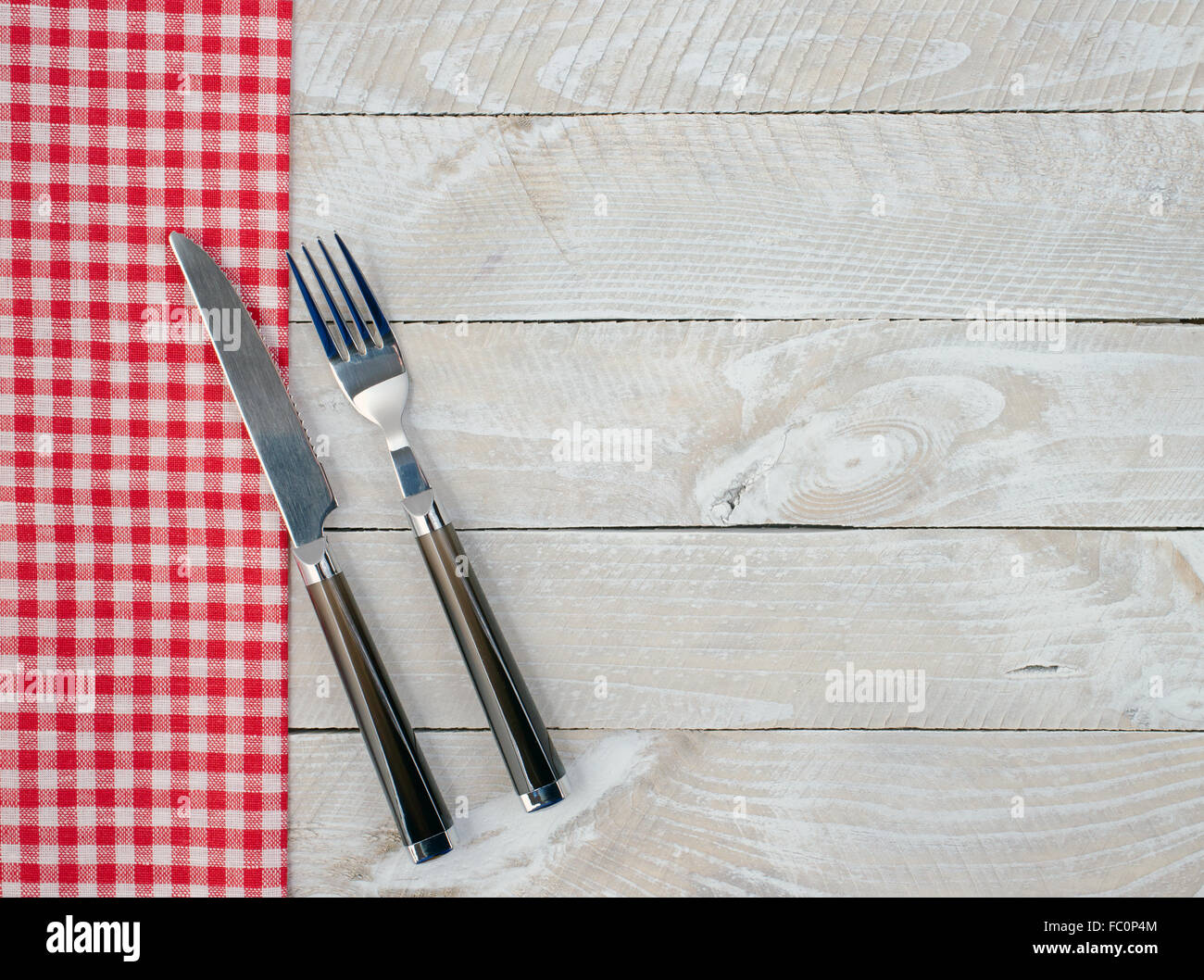 Fork and knife on wooden background Stock Photo - Alamy
