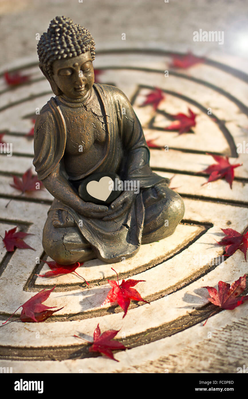 Buddha statue with a heart symbol Stock Photo - Alamy