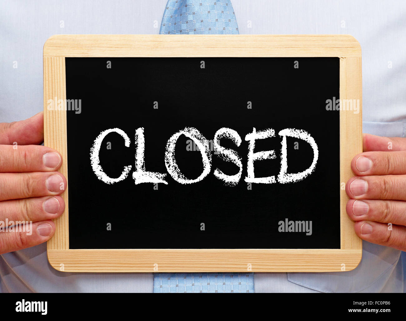 Closed - Businessman with chalkboard Stock Photo - Alamy