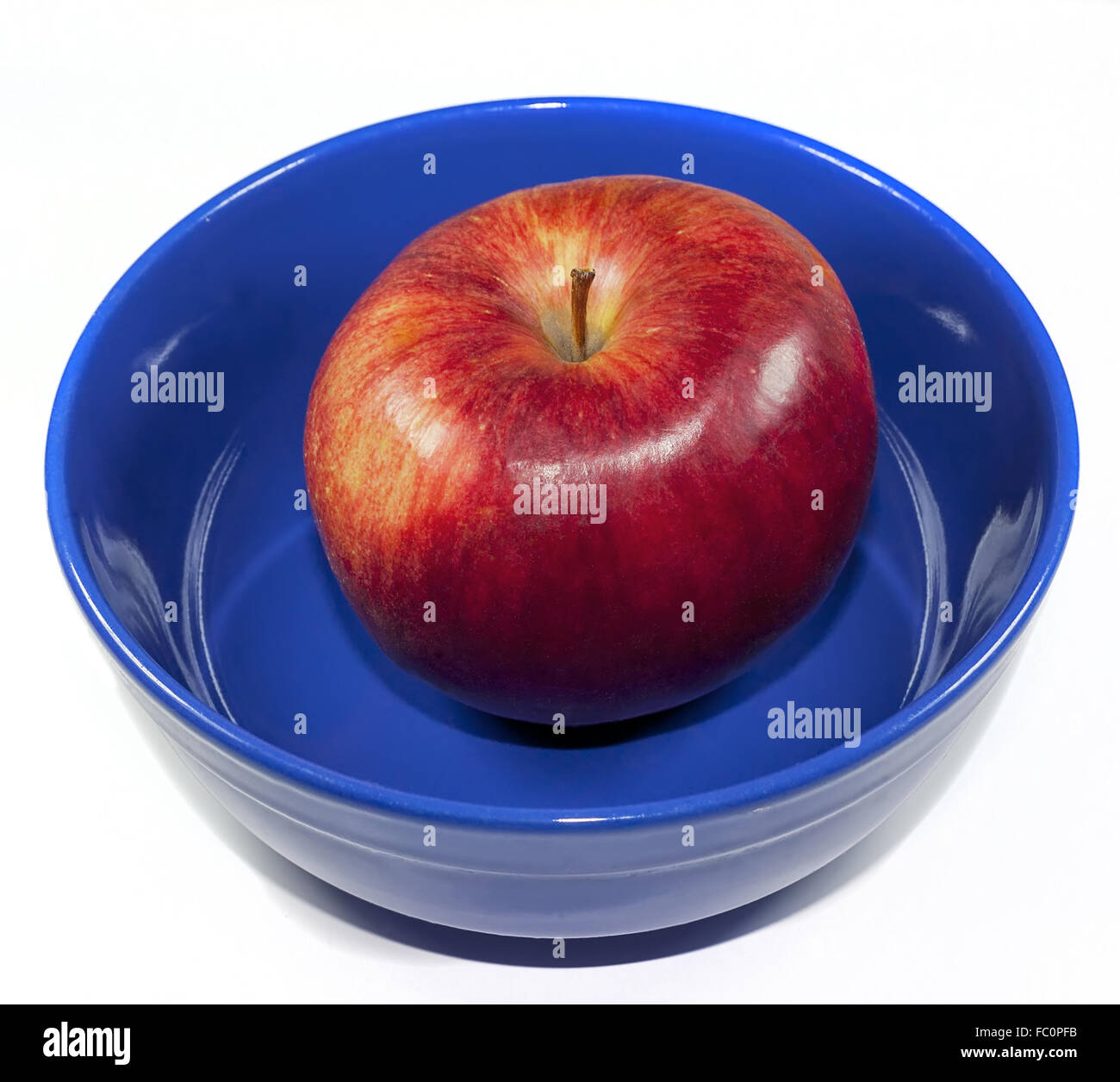 Red apple in a blue bowl Stock Photo - Alamy