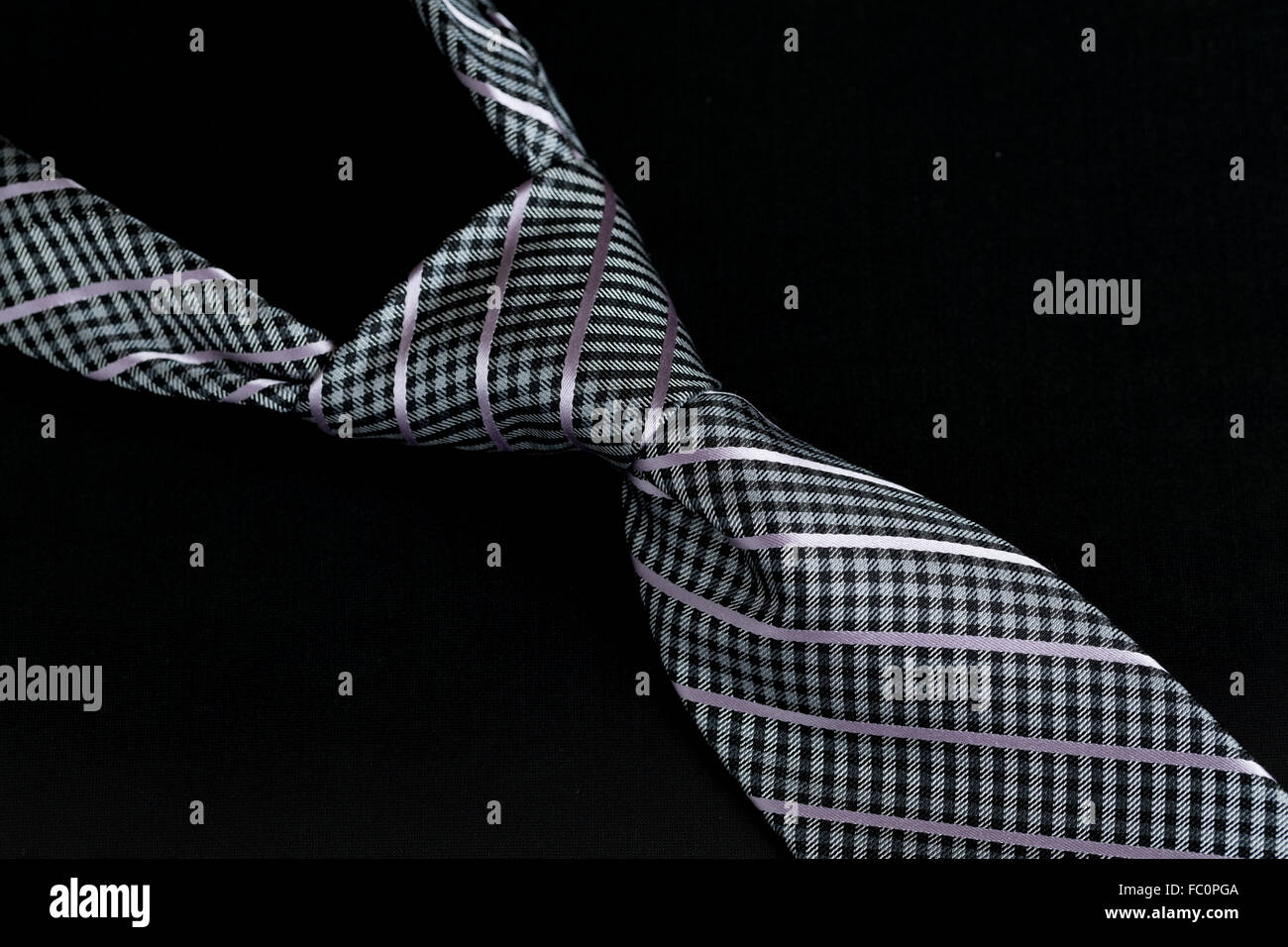 Grey or gray windsor knot on tie isolated against black Stock Photo - Alamy