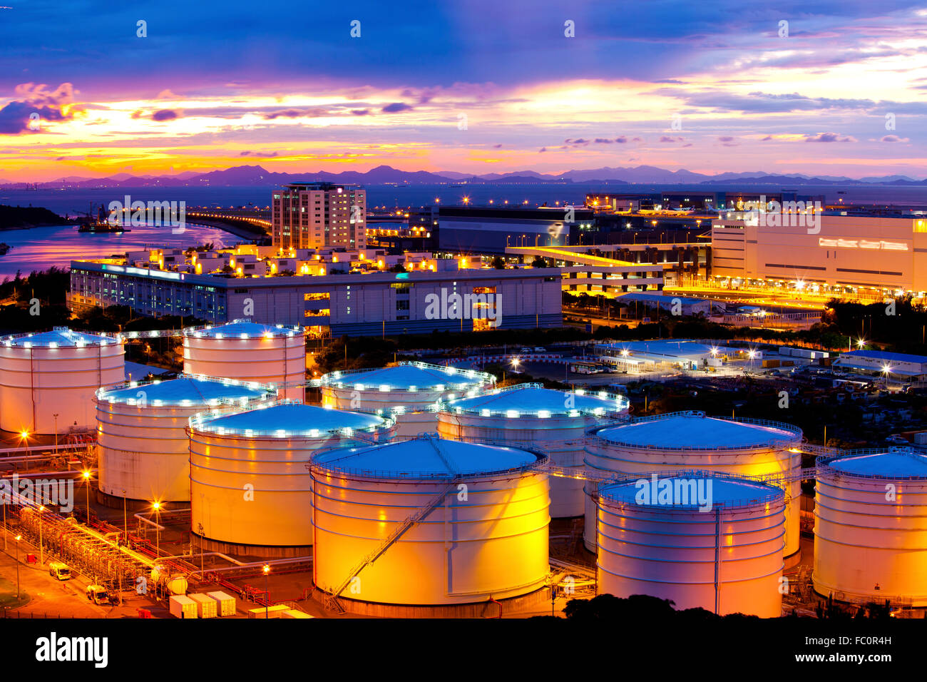 Fuel tanks along sunset moment Stock Photo - Alamy