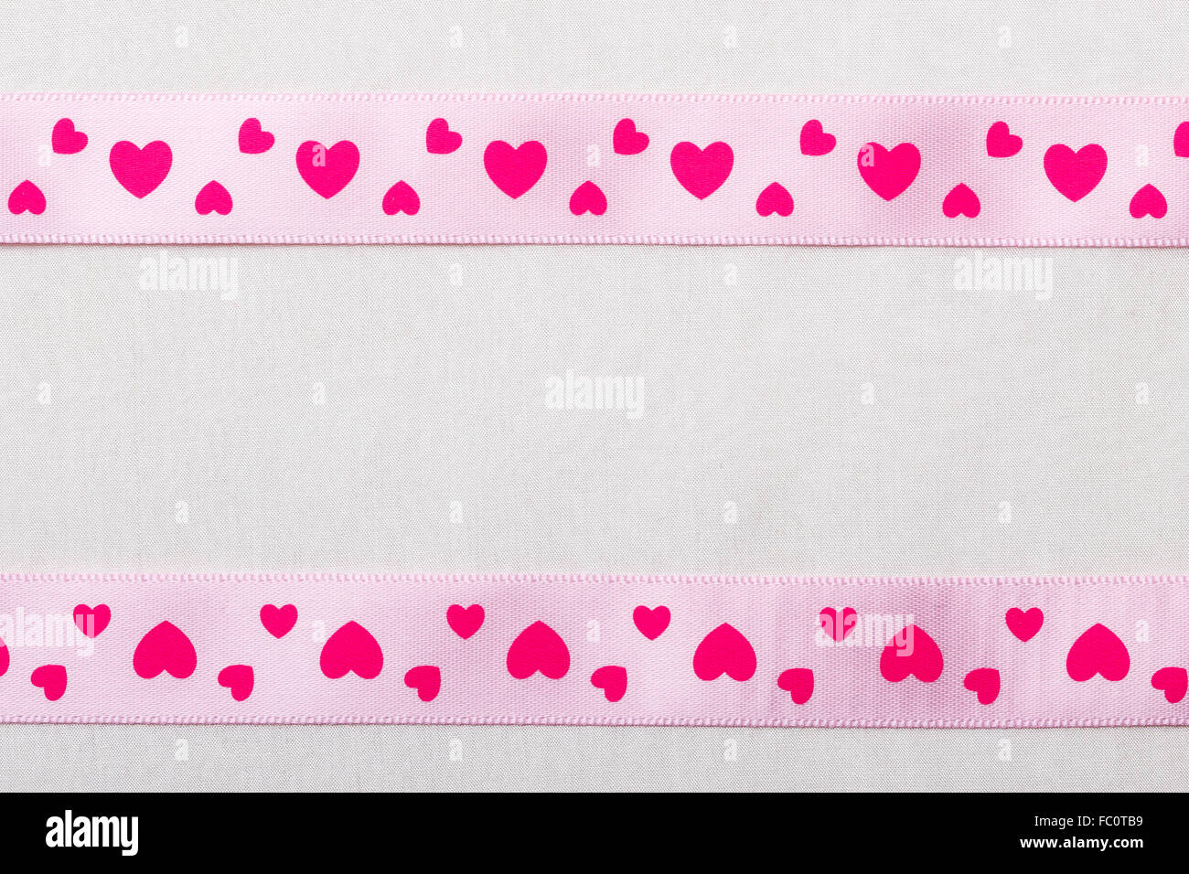 Pink heart ribbon on cloth background Stock Photo - Alamy