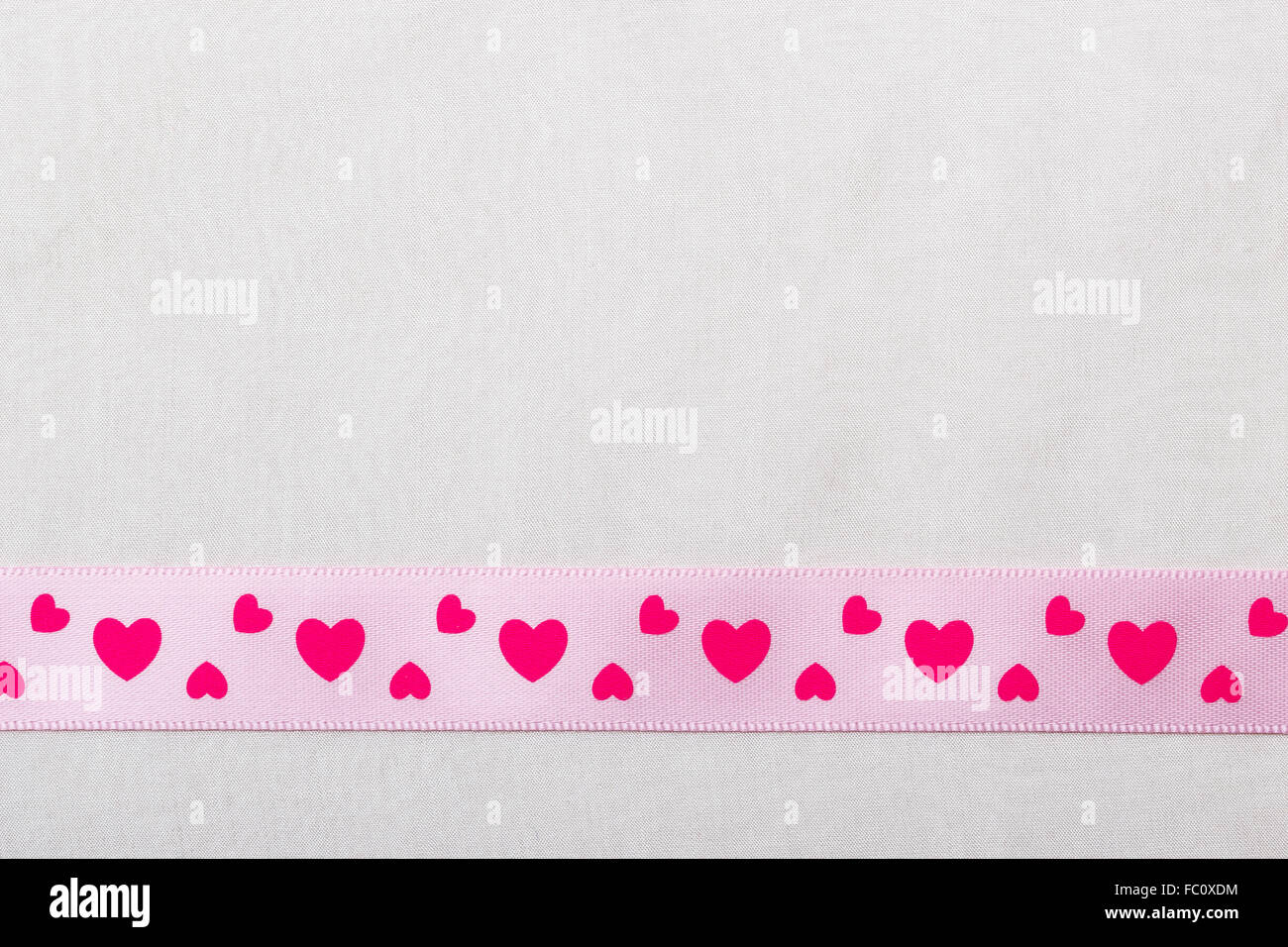 Pink heart ribbon on cloth background Stock Photo - Alamy
