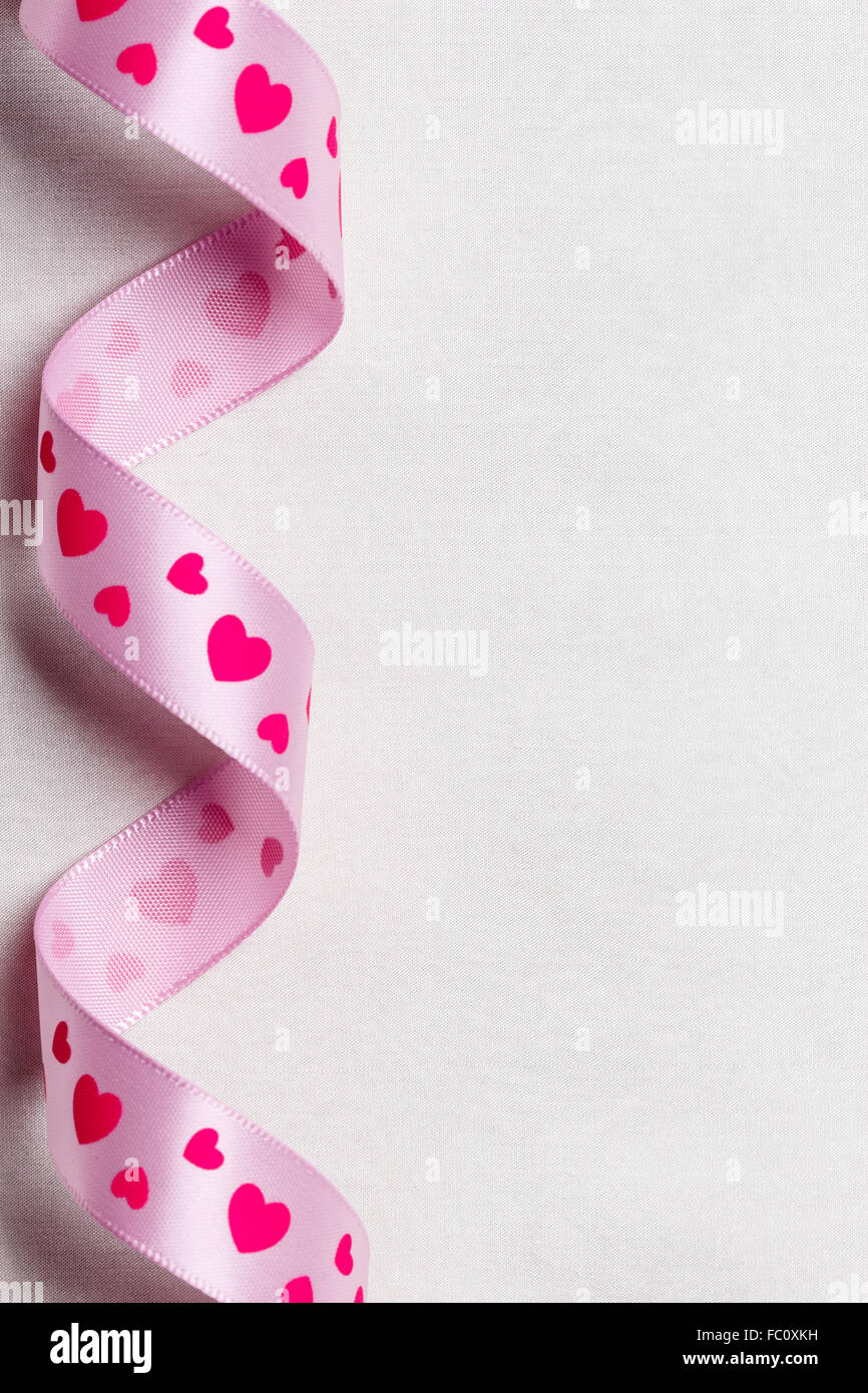 Pink heart ribbon on cloth background Stock Photo - Alamy