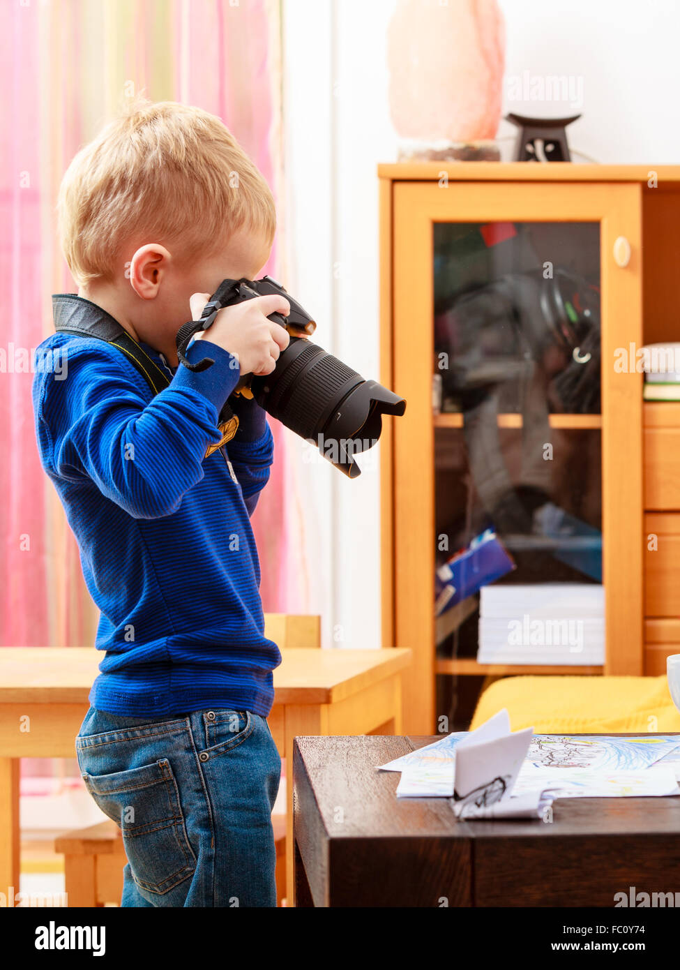 Boy child playing with camera taking photo Stock Photo - Alamy