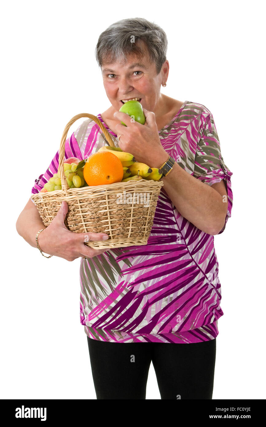 Senior woman biting into an apple Stock Photo - Alamy
