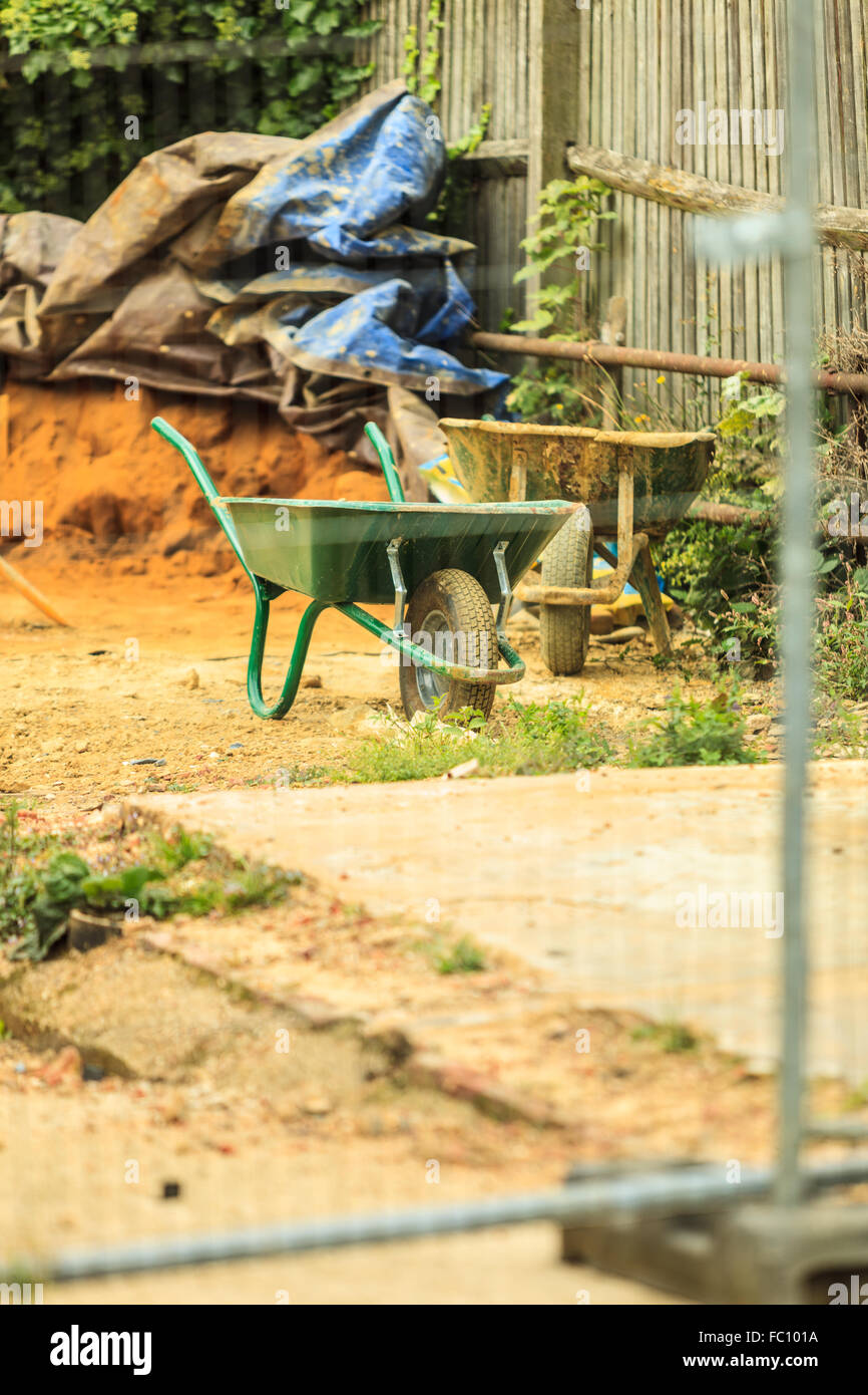 Construction site with green barrow Stock Photo - Alamy