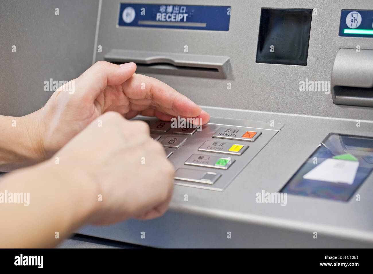 Hand using atm machine Stock Photo - Alamy