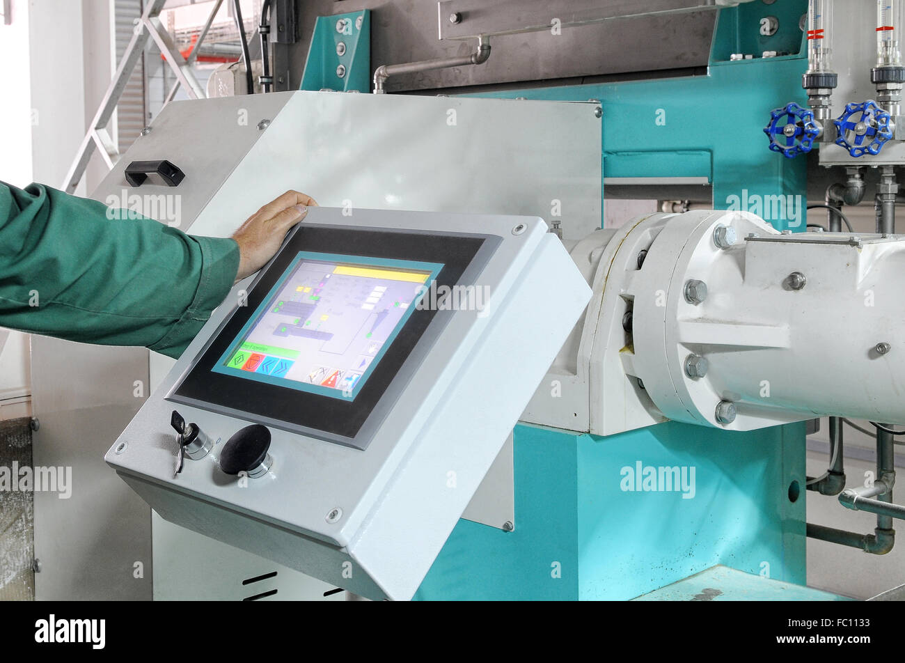 man operating factory machinery Stock Photo - Alamy