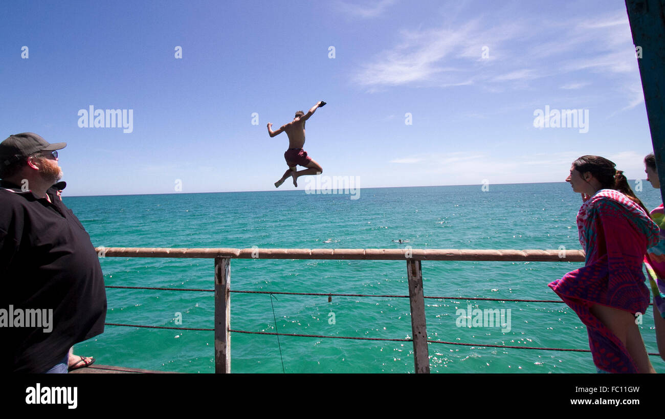 Adelaide, Australia. 20th Jan, 2016. People jump off Henley beach jetty ...