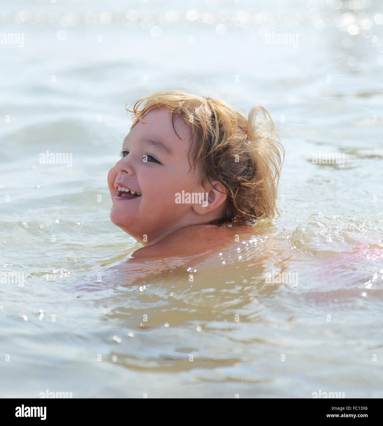 Child playing in sea hi-res stock photography and images - Alamy