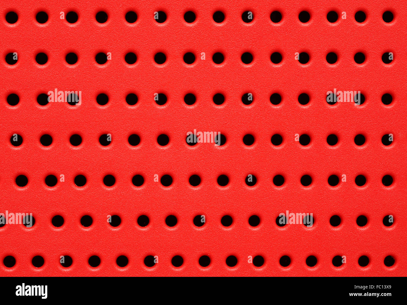 red perforated plastic background Stock Photo - Alamy