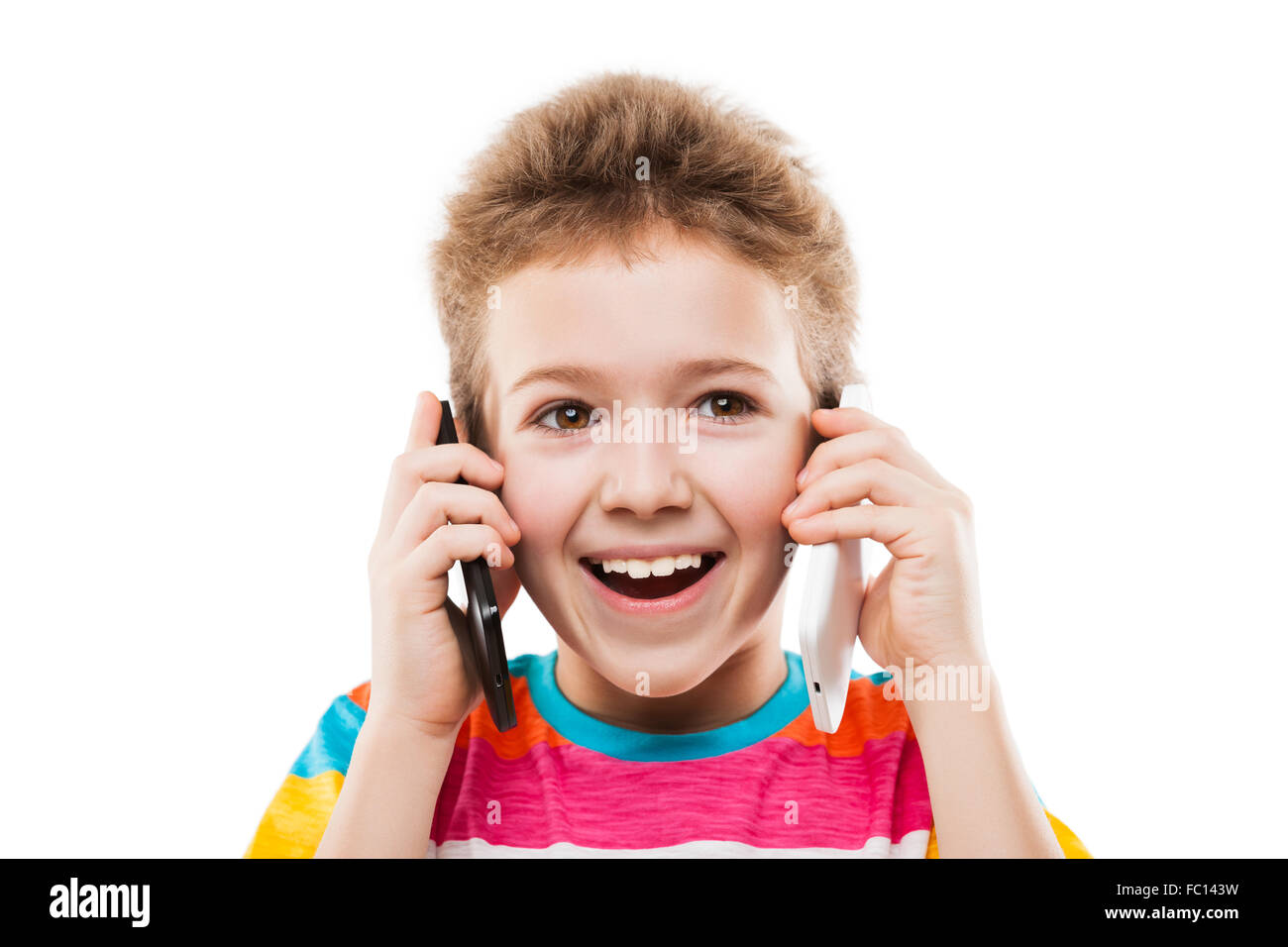 Smiling child boy talking two mobile phones Stock Photo - Alamy