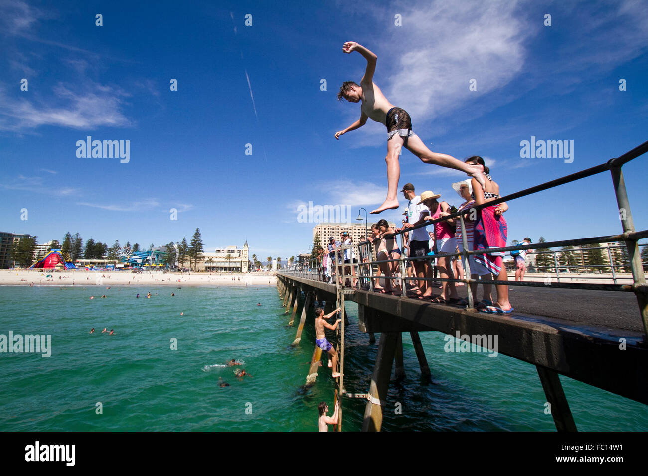 Adelaide, Australia. 20th Jan, 2016. People jump off Glenelg beach ...
