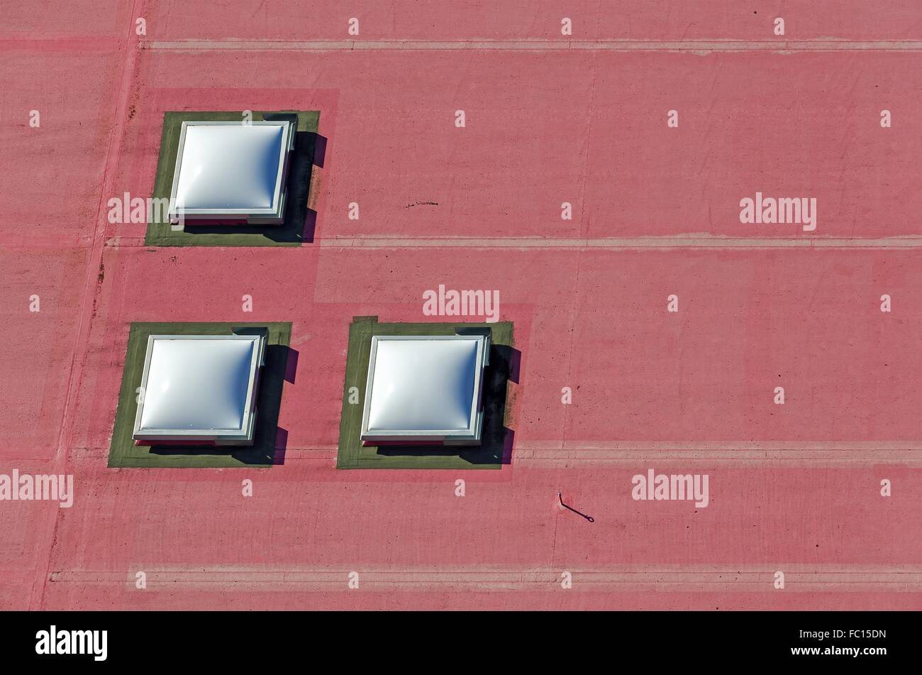 domed rooflights on a red flat roof Stock Photo - Alamy