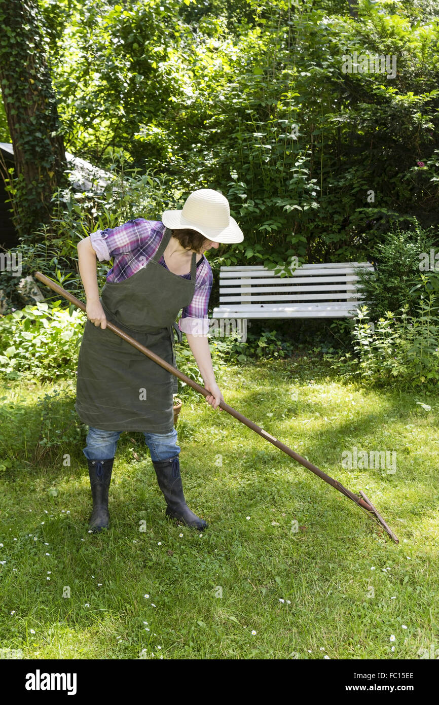 woman with rake Stock Photo - Alamy