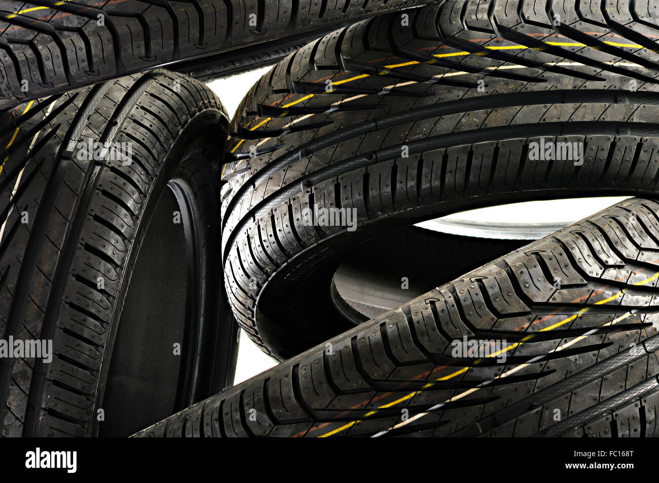 Four new black tires isolated on white Stock Photo - Alamy