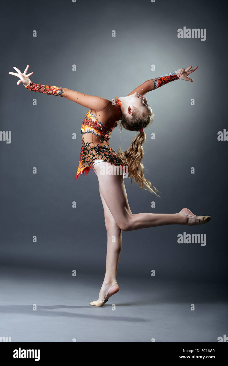 Adorable little gymnast posing in jump Stock Photo - Alamy
