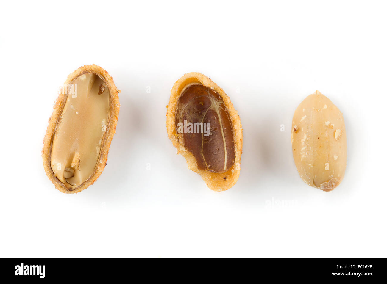 Roasted salty and spicy peanuts broken and show inside on isolated ...