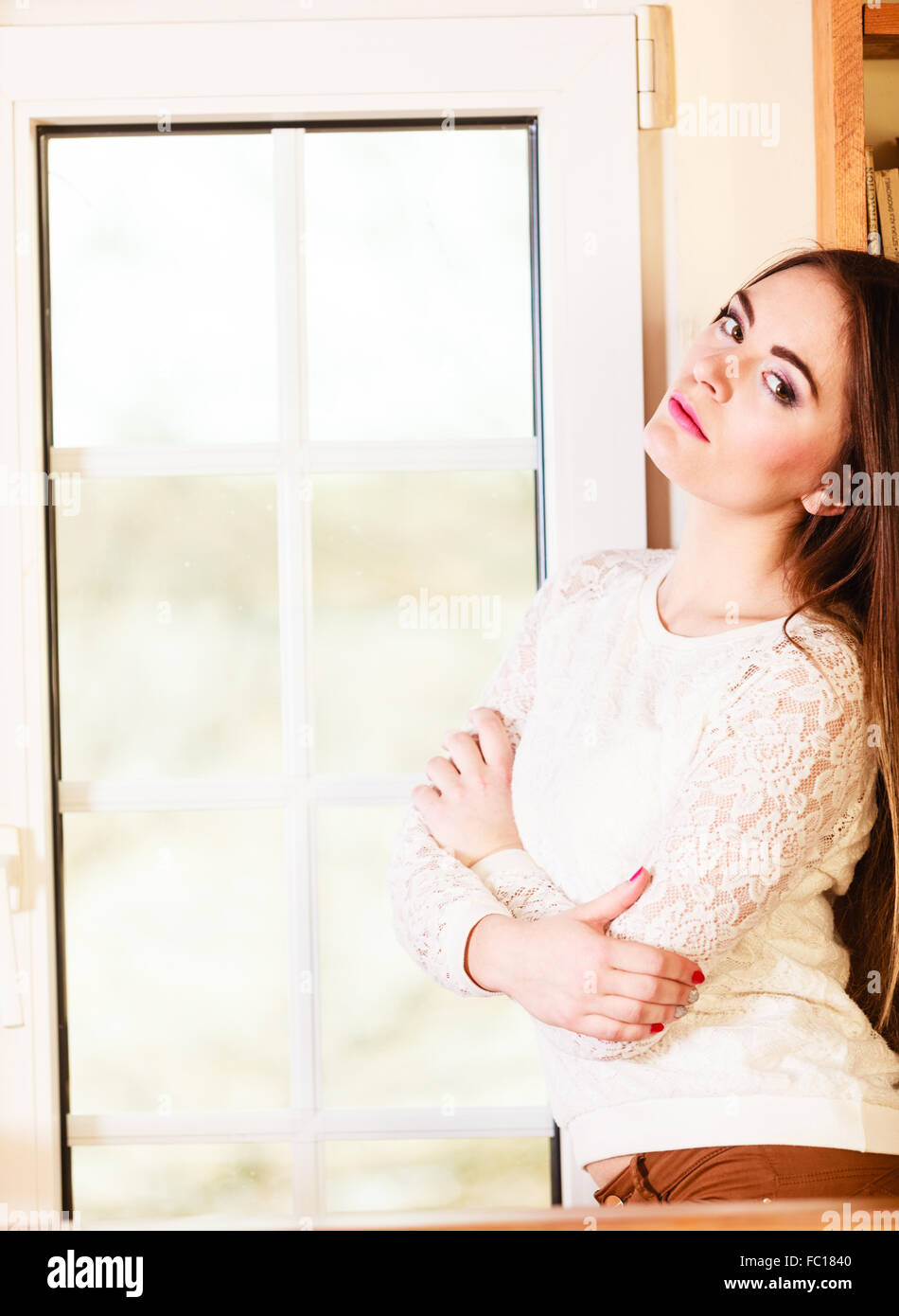 Beautiful woman looking through window Stock Photo - Alamy