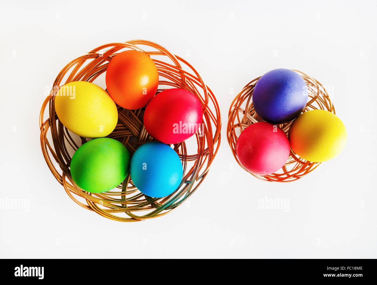 Colorful easter eggs. Two baskets with colored Easter eggs. Top view ...