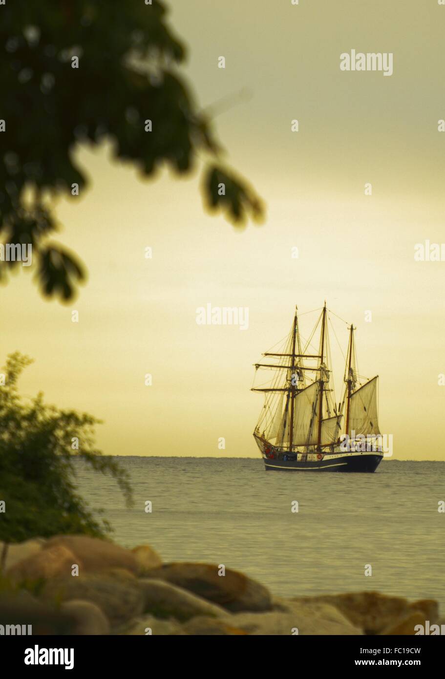 Beautiful sailing ship on sea at dusk Stock Photo - Alamy