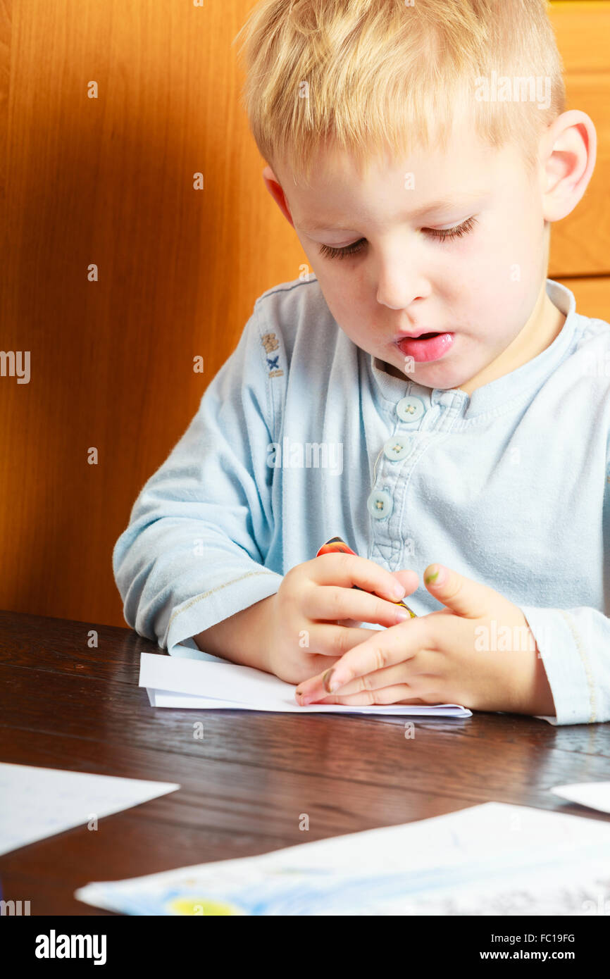 boy child with pen writing doing homework. At home Stock Photo - Alamy