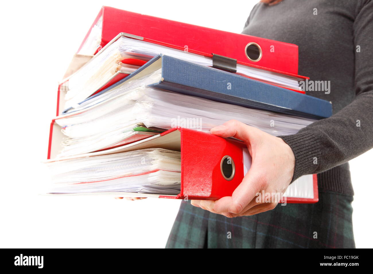 Female office worker carrying a stack of files Stock Photo - Alamy