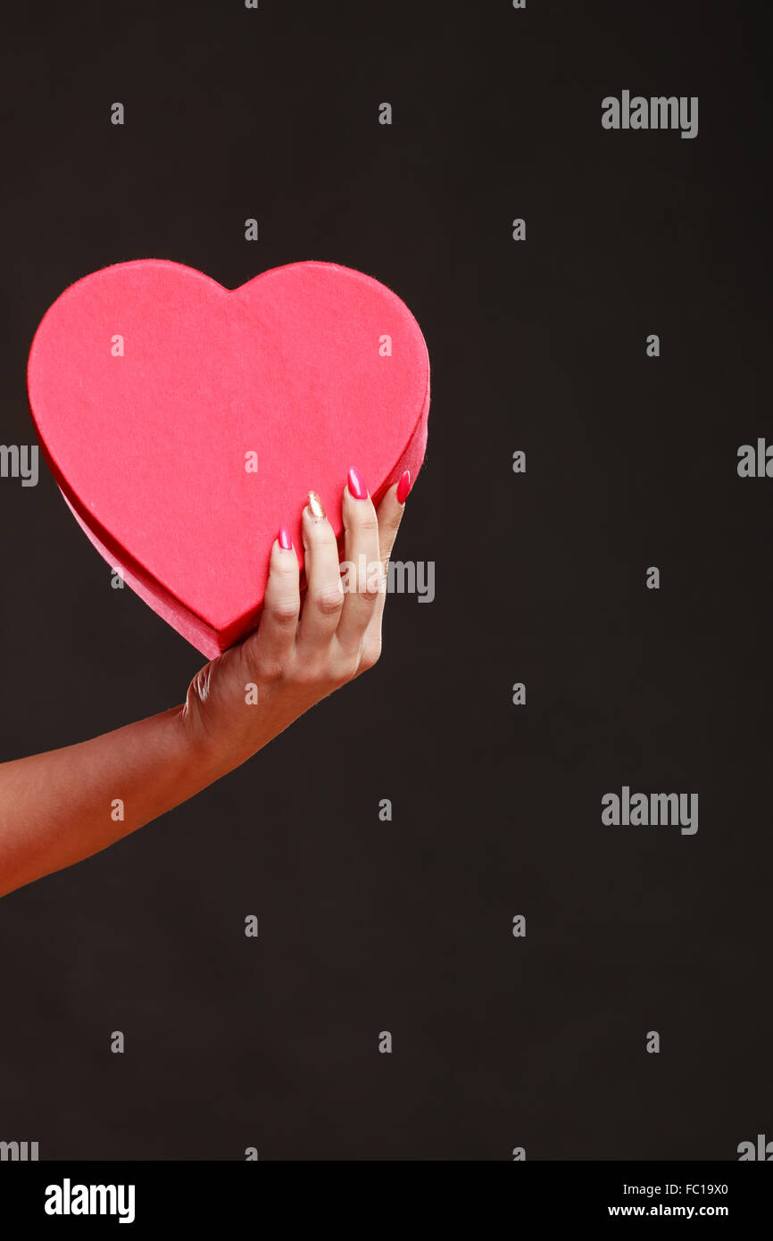 Woman hand holding heart box Stock Photo - Alamy