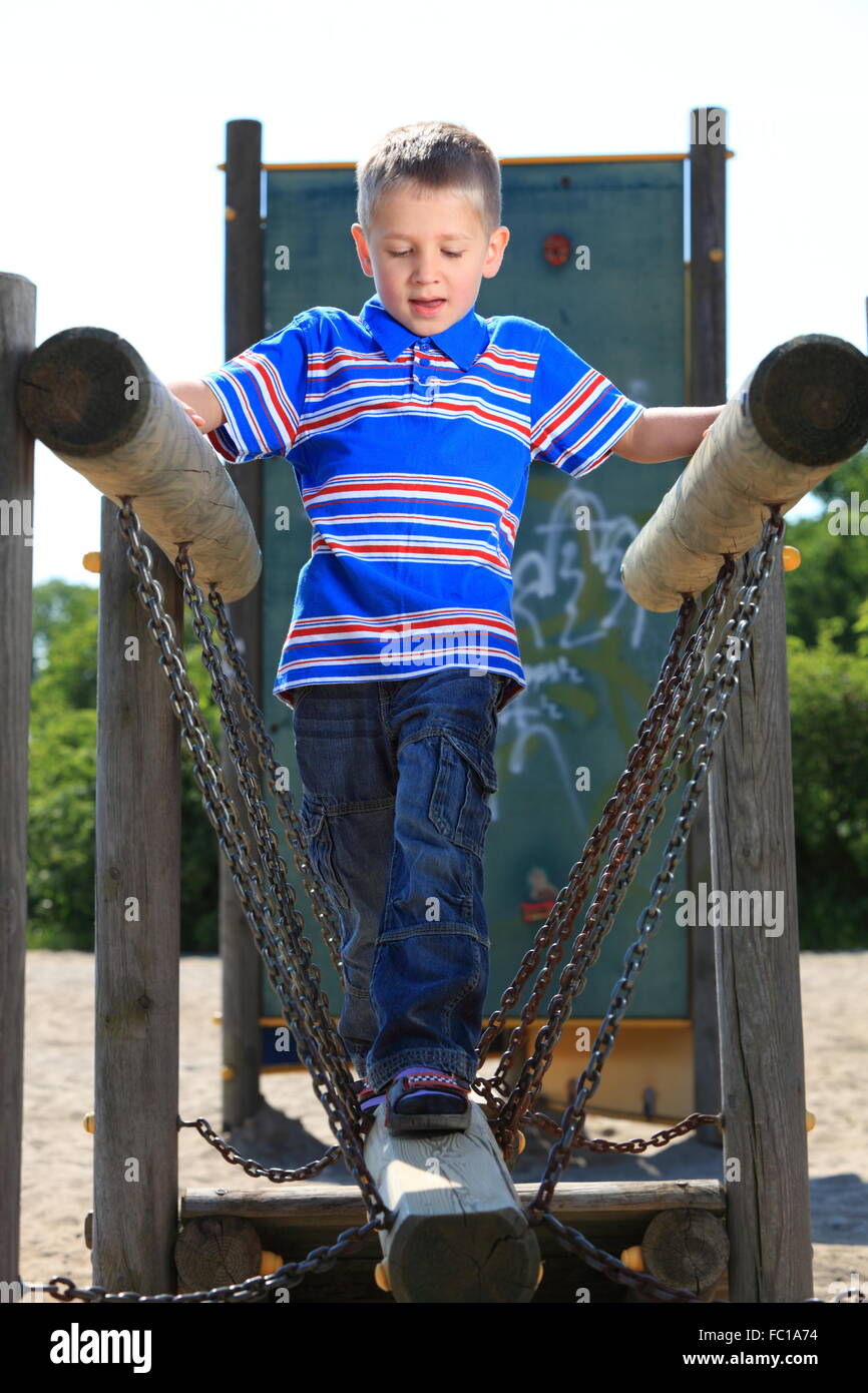 child in playground, kid in action playing Stock Photo - Alamy