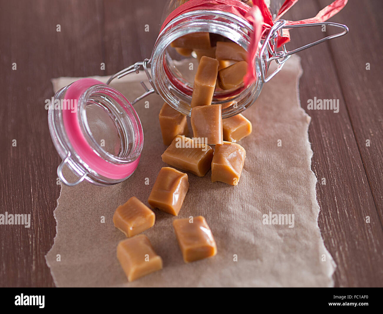 Caramel sweets in a glass Stock Photo - Alamy