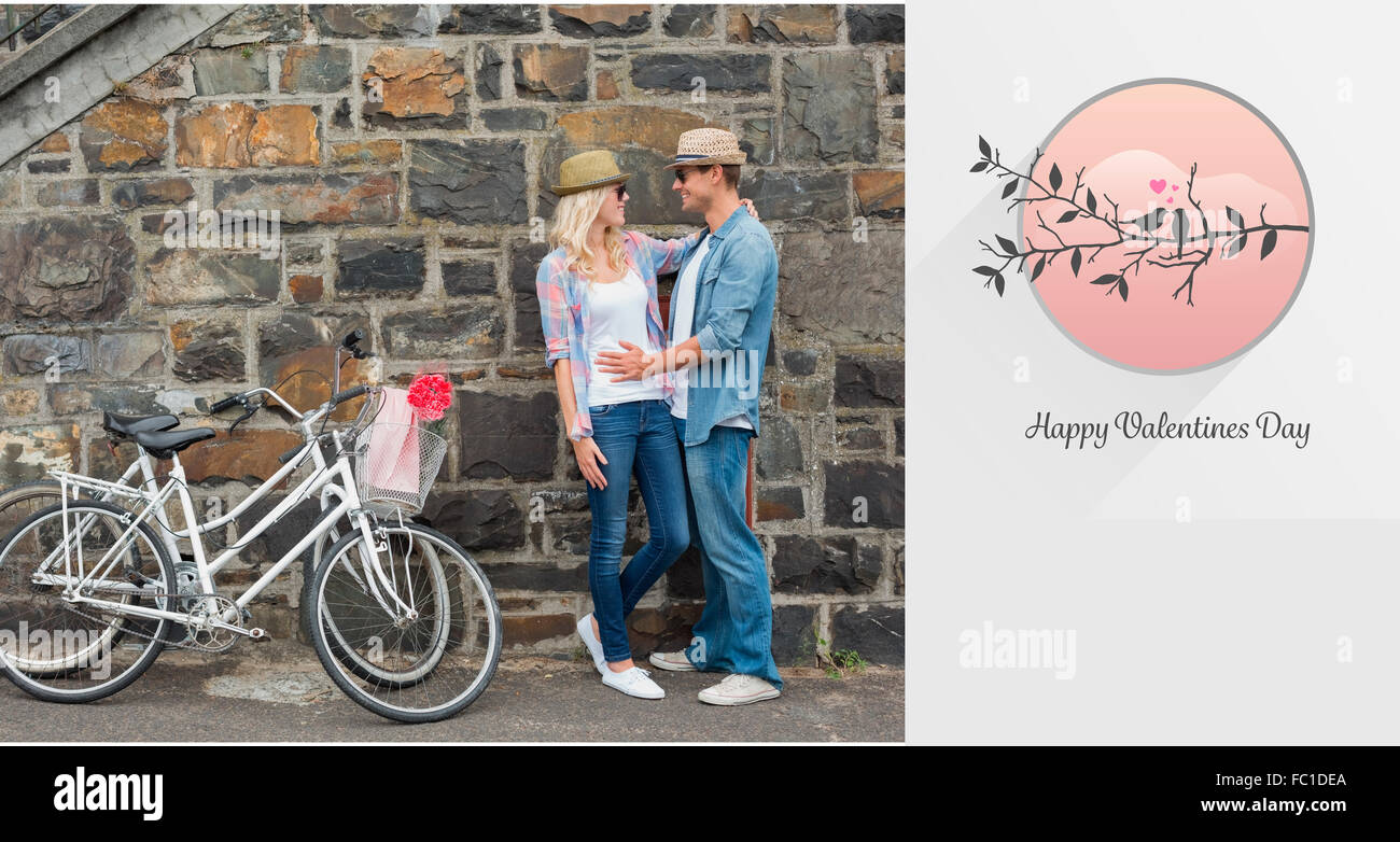 Composite image of hip young couple hugging by brick wall with their ...
